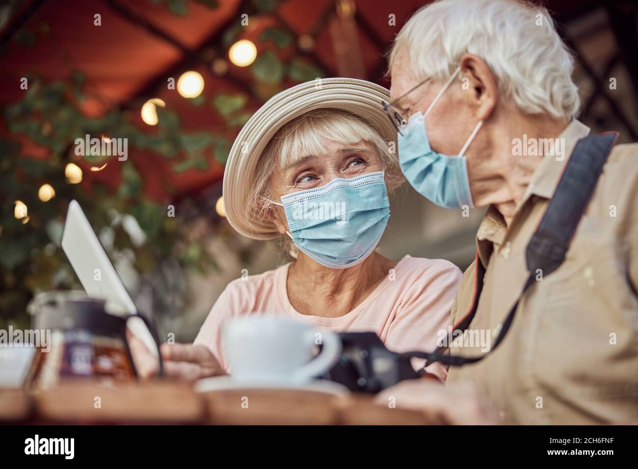Two elderly people sitting in a cafe Stock Photo - Alamy