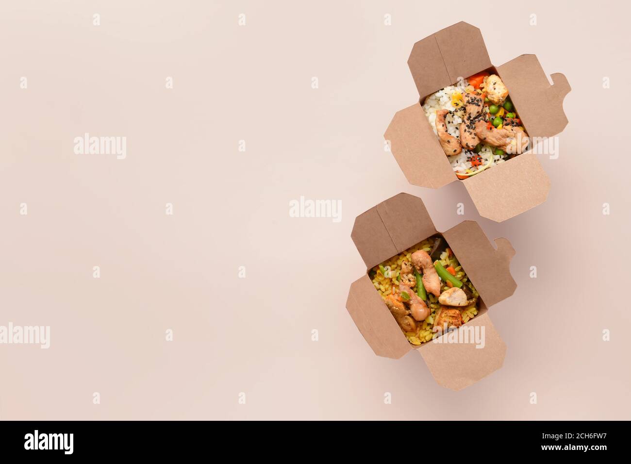 Boxes with tasty fried rice on light background Stock Photo - Alamy