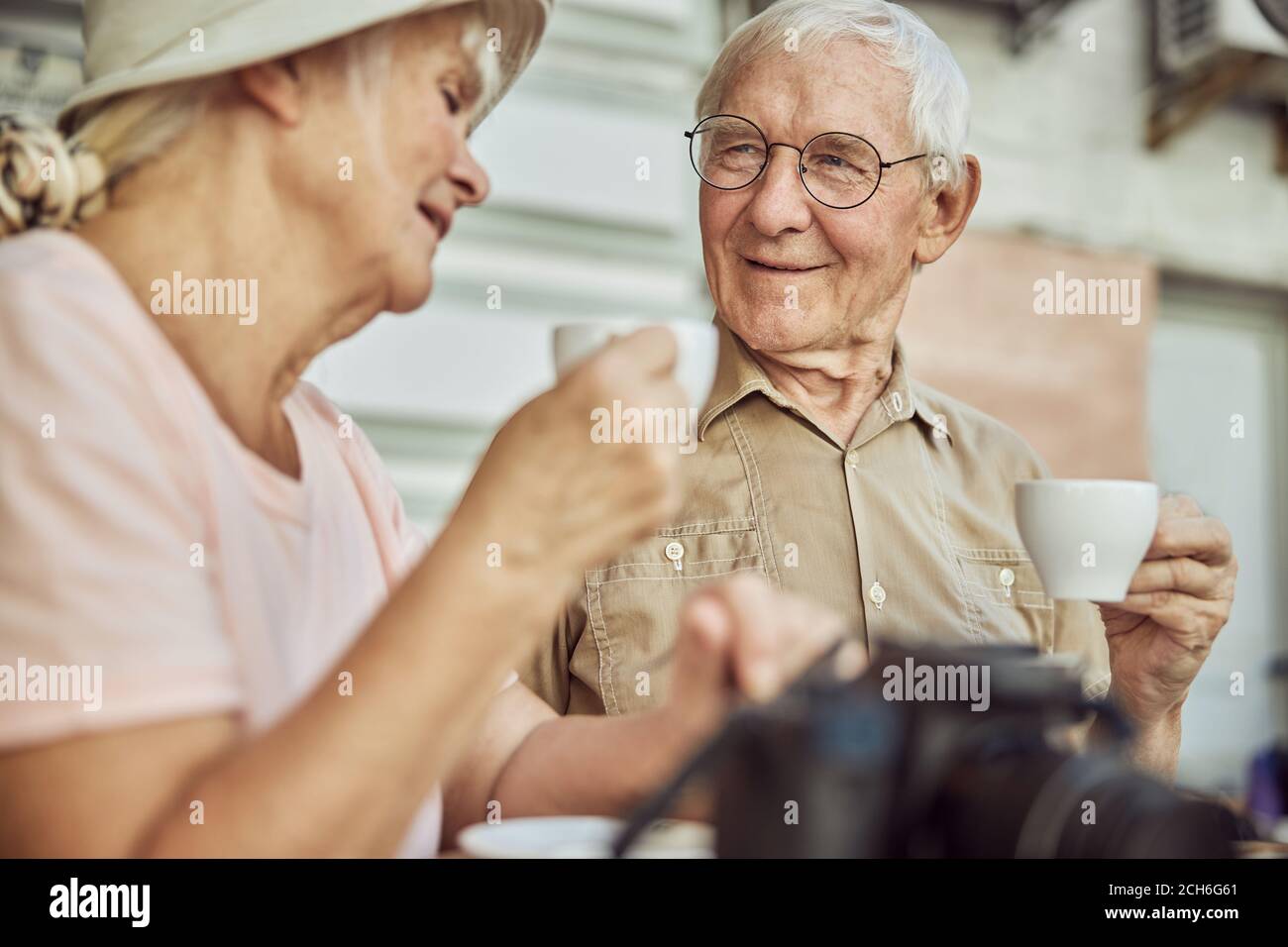 Two pensioners sitting in an outdoor cafe Stock Photo - Alamy