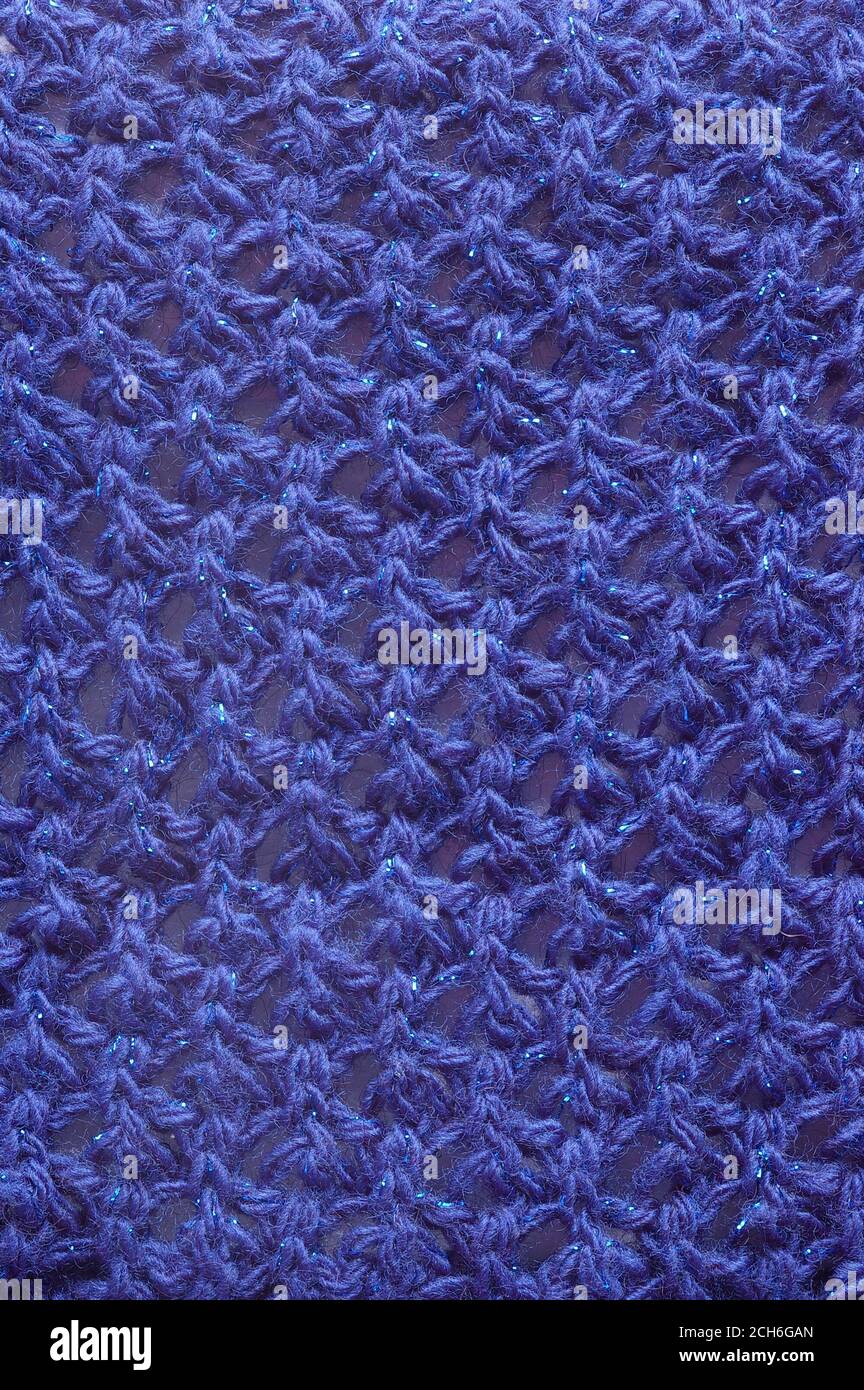 Vertical closeup of dark blue woolen texture with sparkling tinsel ...