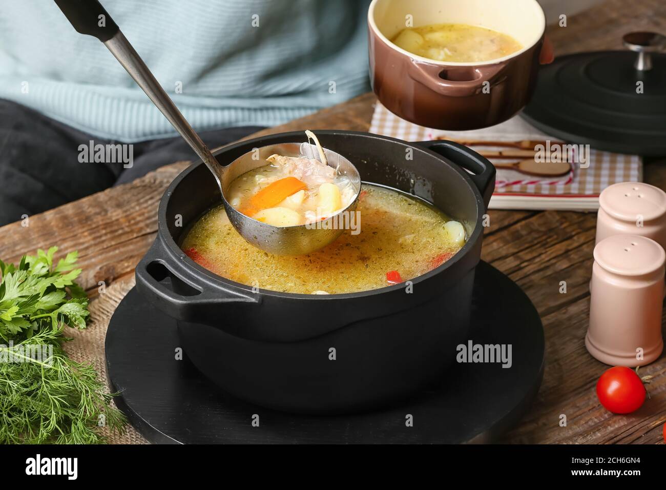 Pouring broth into pot hi-res stock photography and images - Alamy