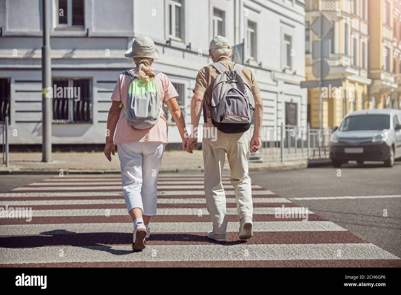 Woman and man walking across street hi-res stock photography and images ...