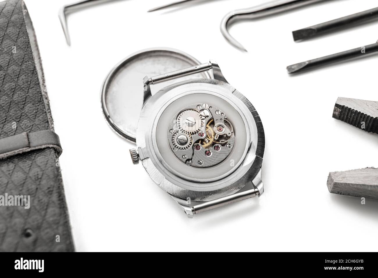 Watch and tools for repair on white background Stock Photo - Alamy