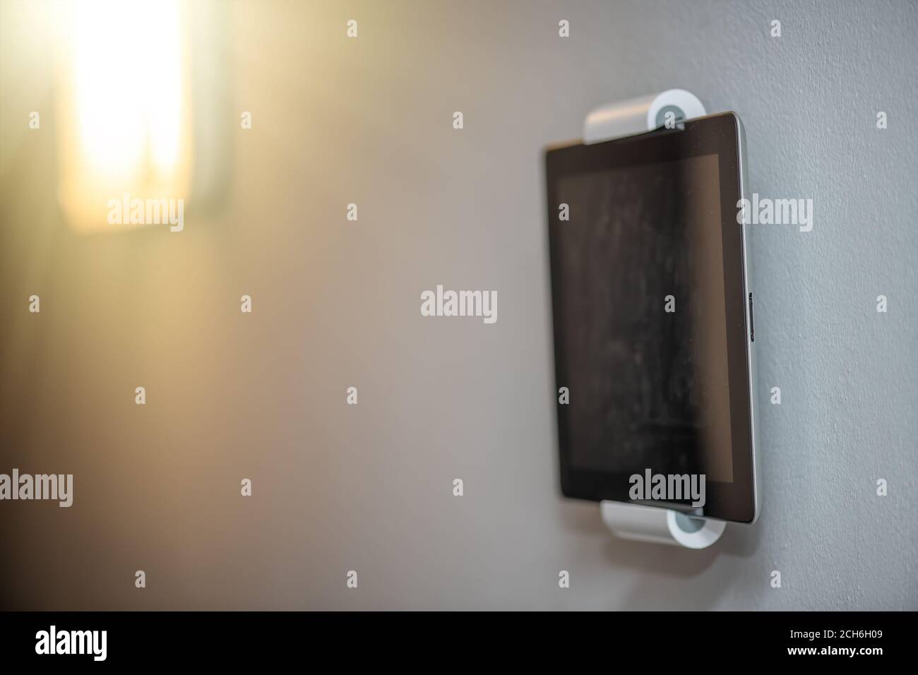 Tablet attached to the wall at home Stock Photo - Alamy