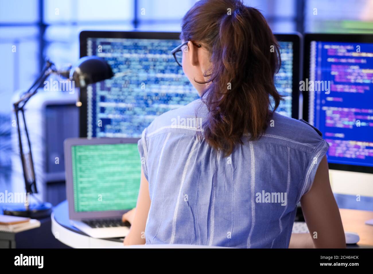 Female programmer working in office at night Stock Photo - Alamy
