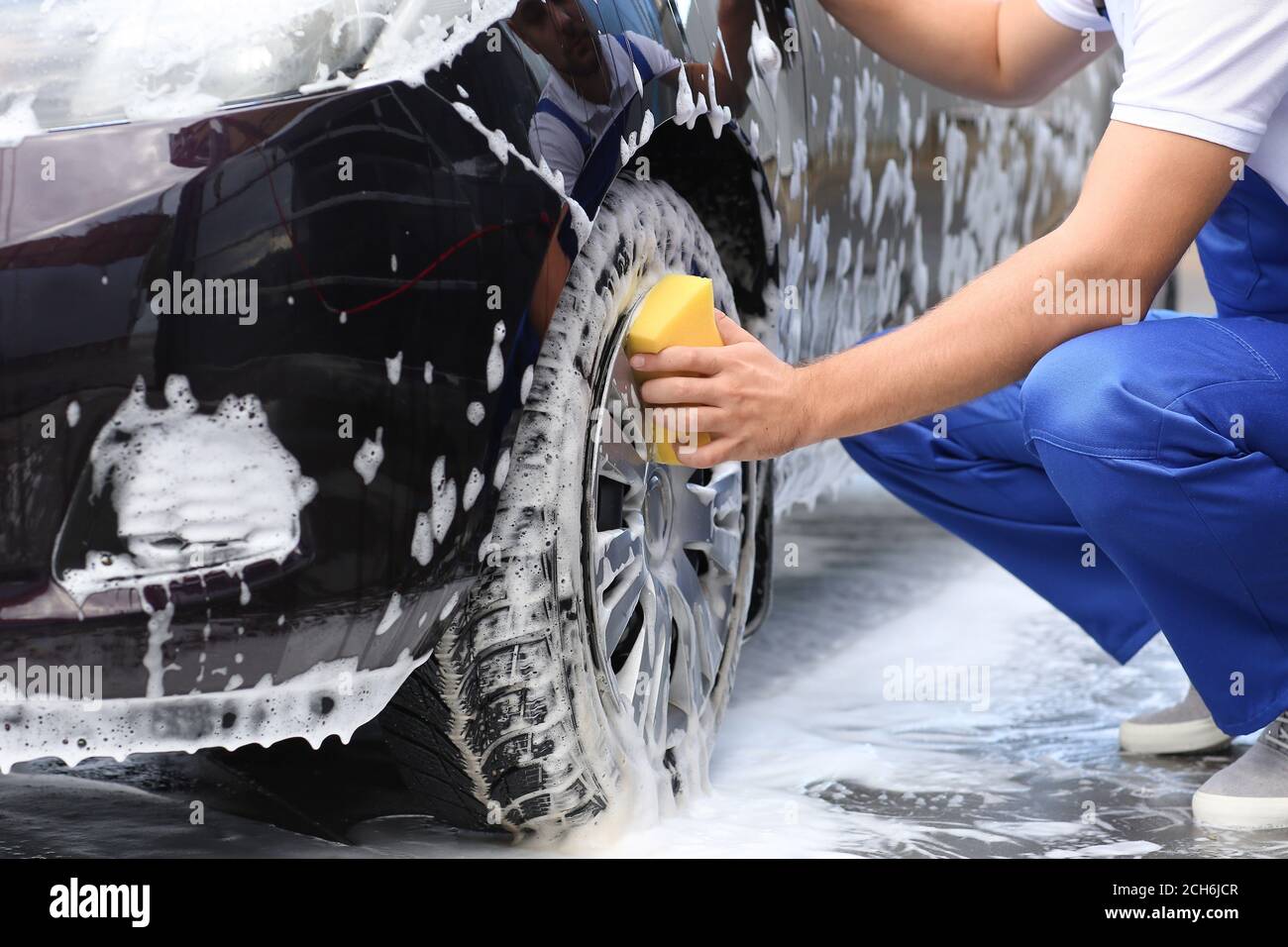 Male worker washing car outdoors Stock Photo - Alamy