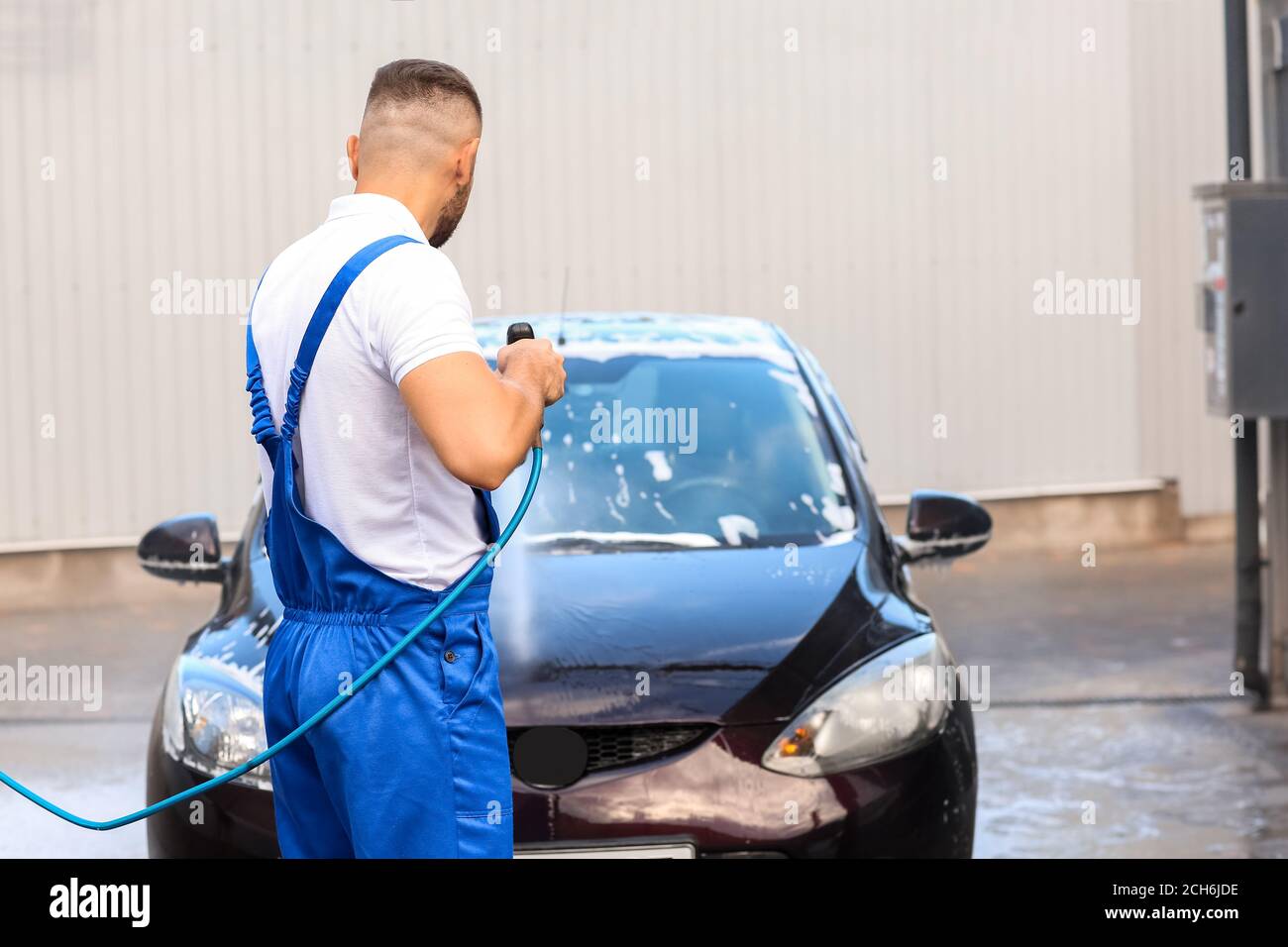 Male worker washing car outdoors Stock Photo - Alamy