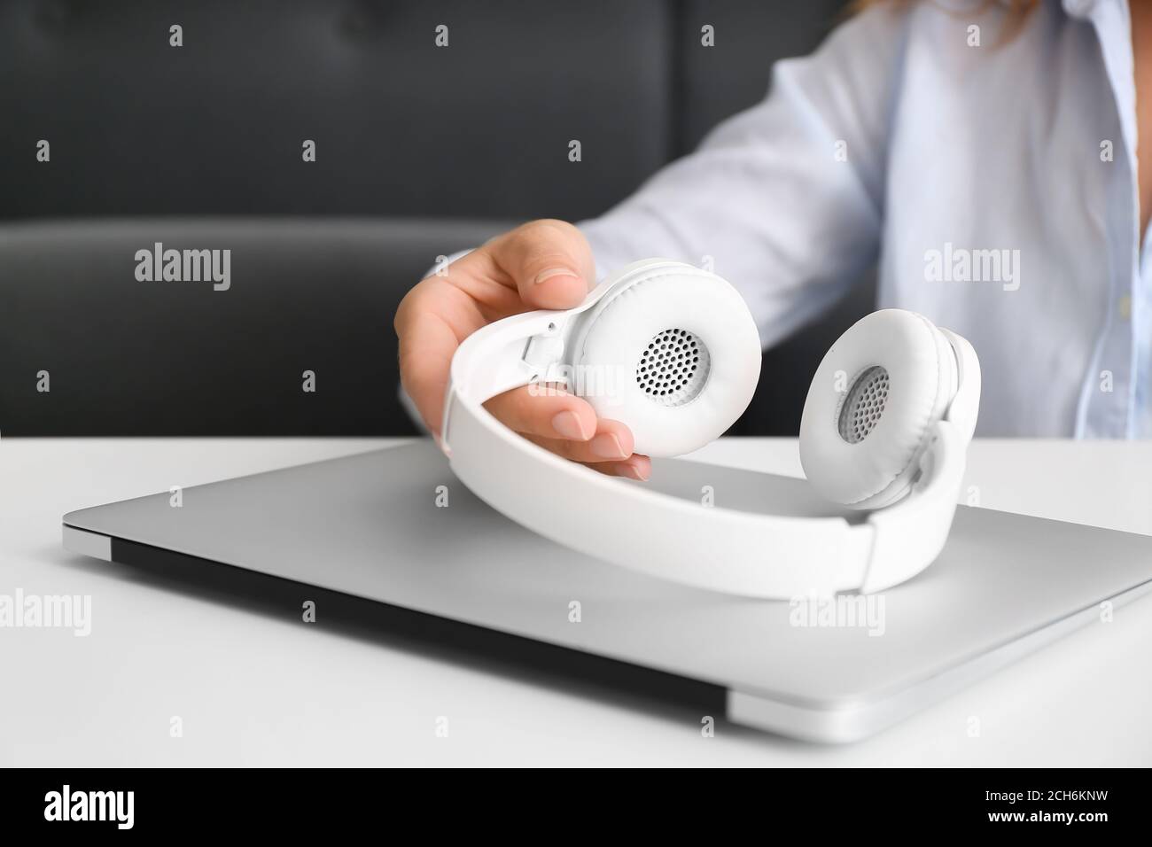 Woman with headphones and laptop at home, closeup Stock Photo - Alamy