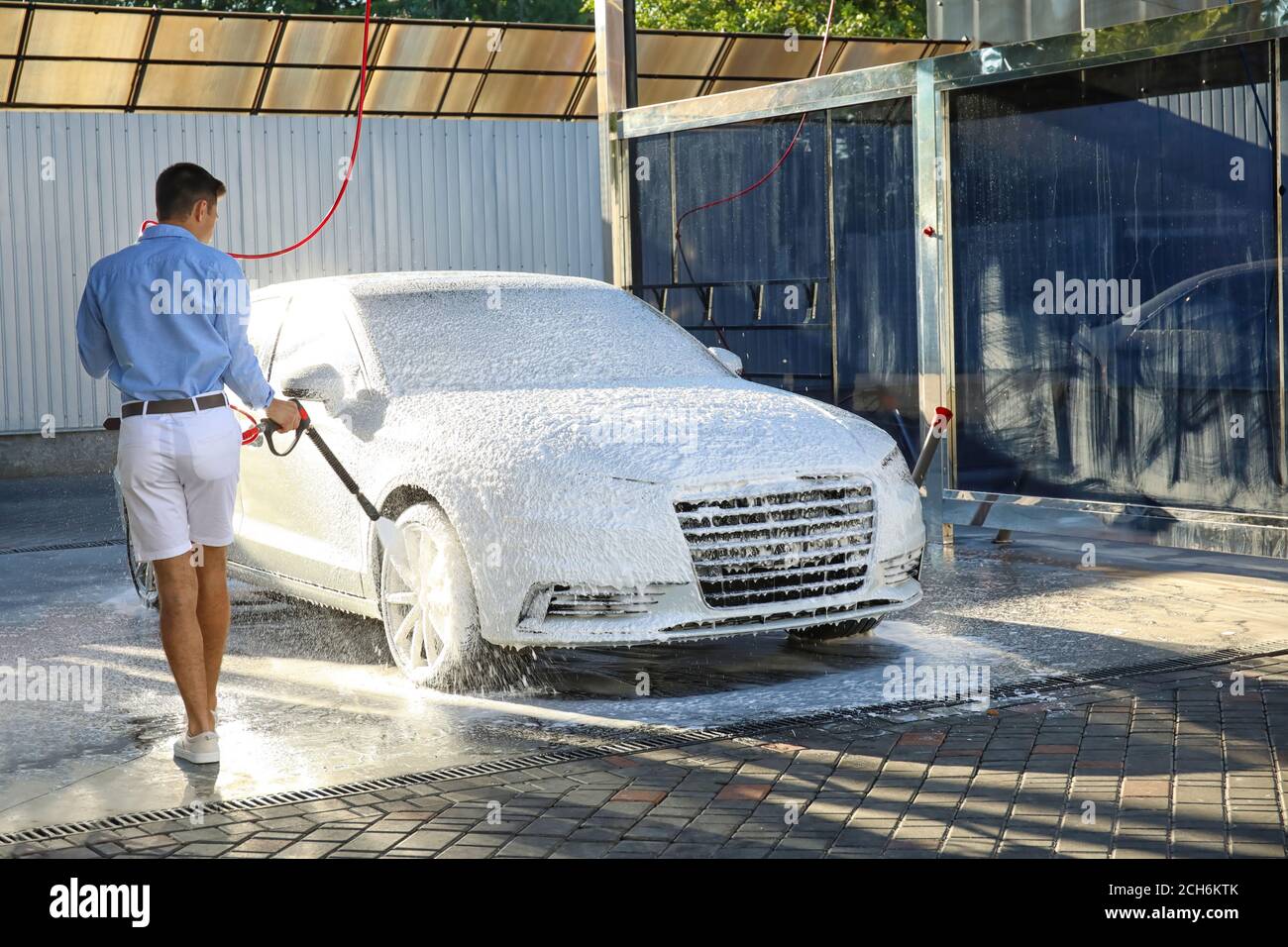 Man washing his car outdoors Stock Photo - Alamy