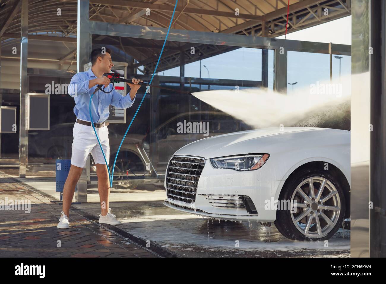 Man washing his car outdoors Stock Photo - Alamy