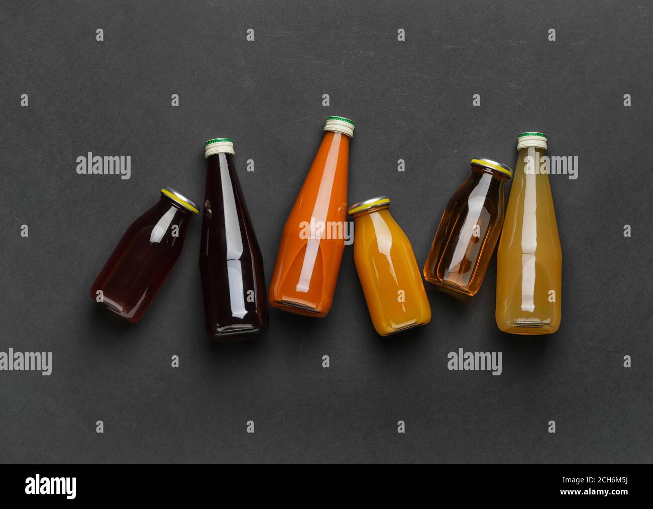 Bottles of juices on dark background Stock Photo - Alamy