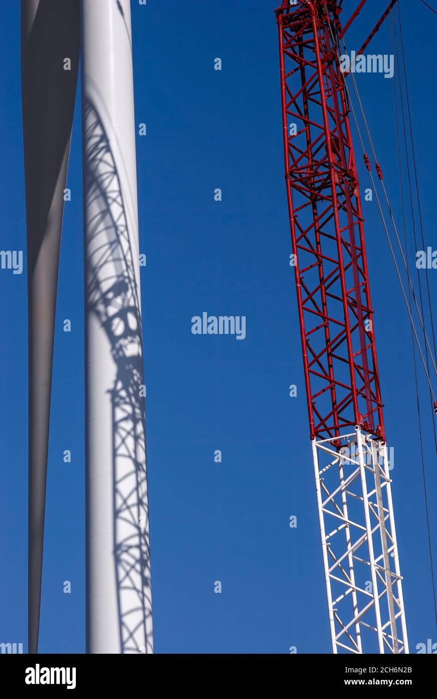 Wind turbine blade and column, with huge crane boom during construction ...