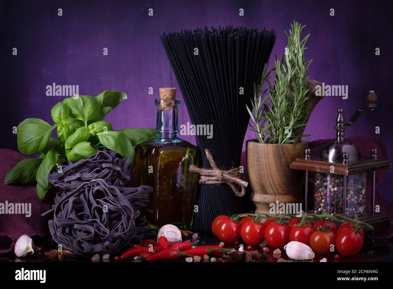 Various pasta and macaroni with condiments on purple background Stock ...