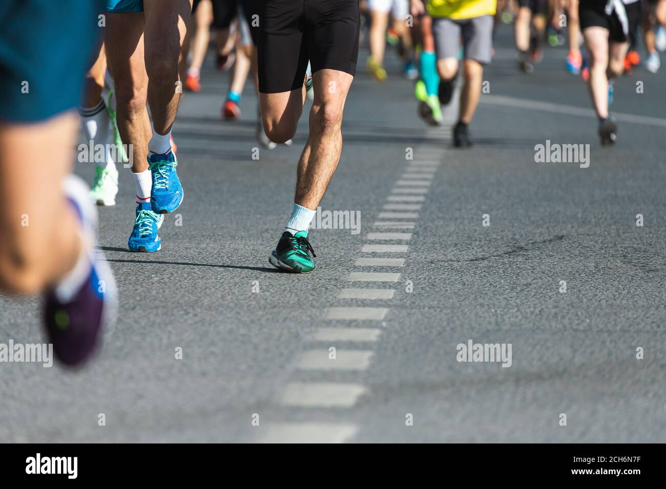 A close-up of the legs of the running track and field athletes on the ...