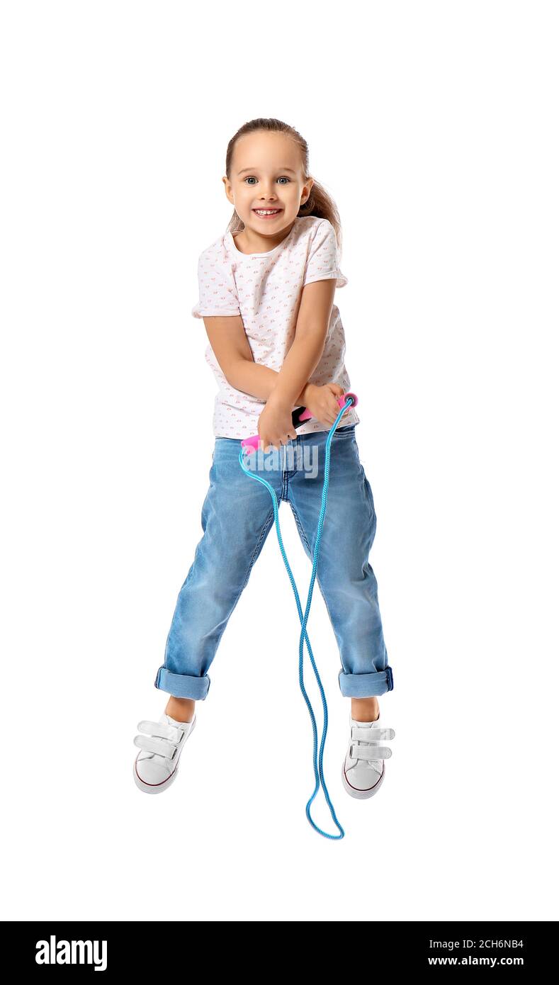 Cute little girl jumping rope against white background Stock Photo - Alamy