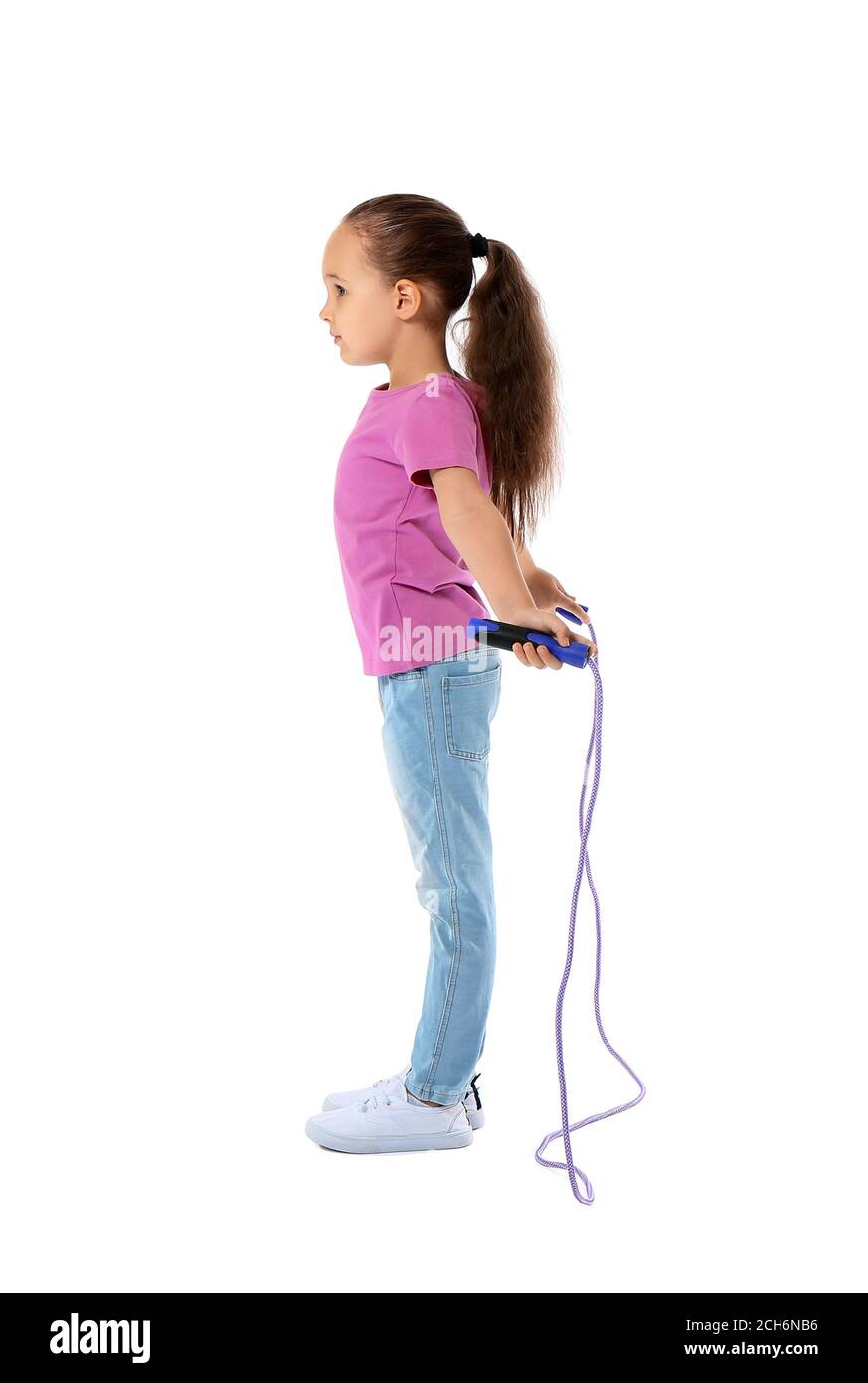 Cute little girl jumping rope against white background Stock Photo - Alamy
