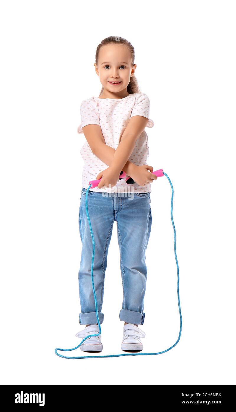 Cute little girl jumping rope against white background Stock Photo - Alamy