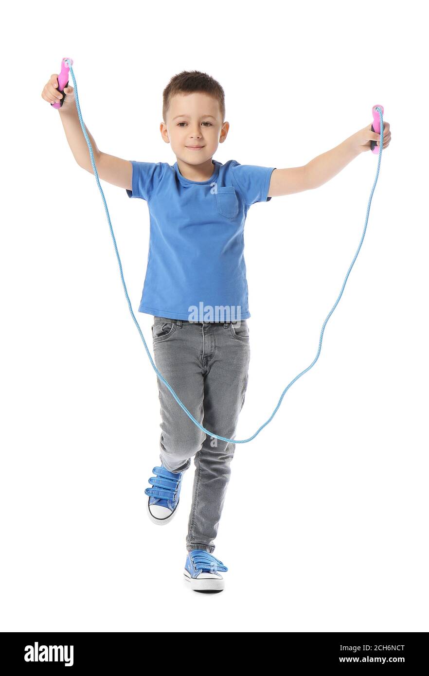 Cute little boy jumping rope against white background Stock Photo - Alamy