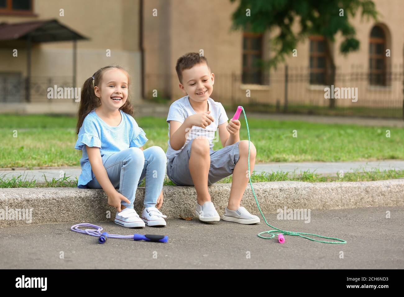 Cute little children with jumping ropes outdoors Stock Photo - Alamy