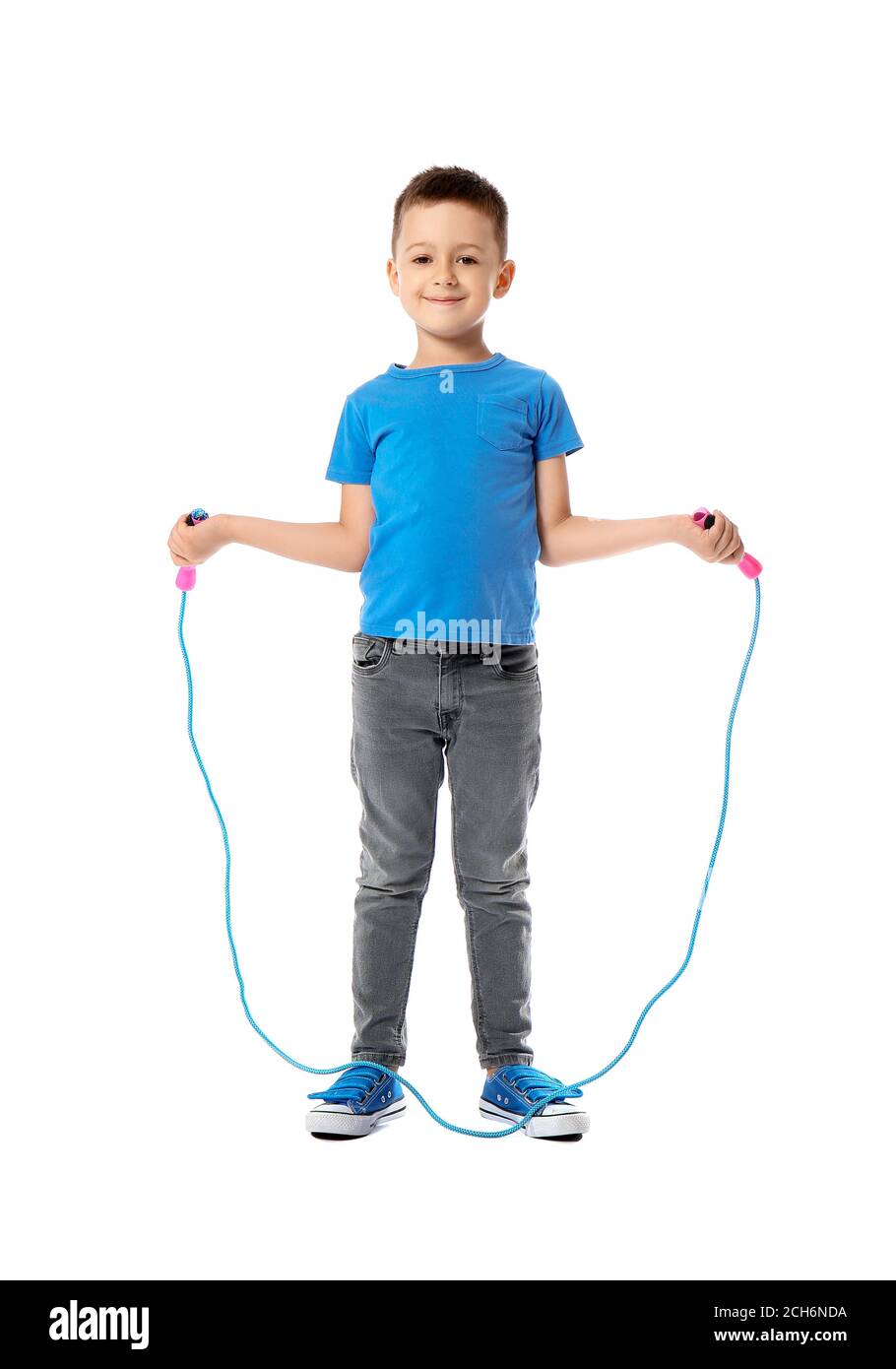 Cute little boy jumping rope against white background Stock Photo - Alamy