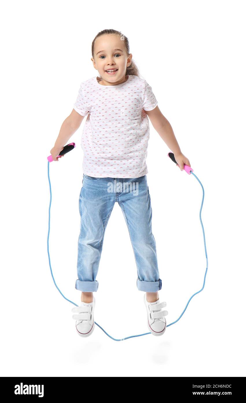 Cute little girl jumping rope against white background Stock Photo - Alamy