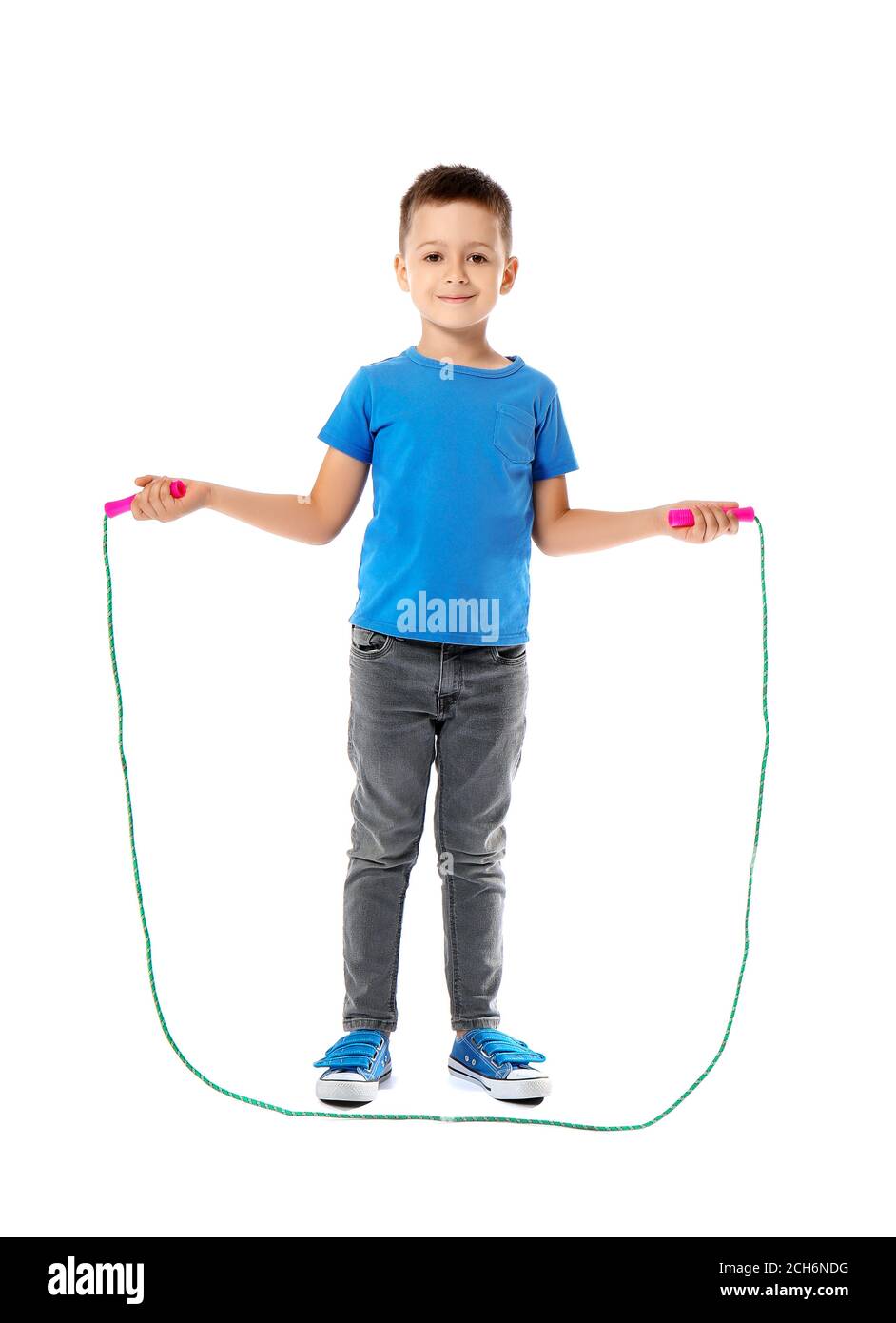 Cute little boy jumping rope against white background Stock Photo - Alamy