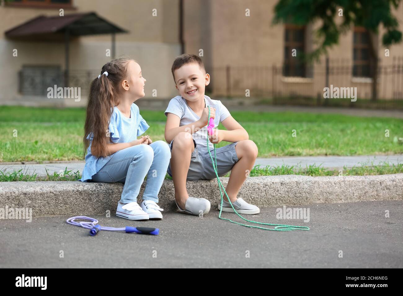 Cute little children with jumping ropes outdoors Stock Photo - Alamy