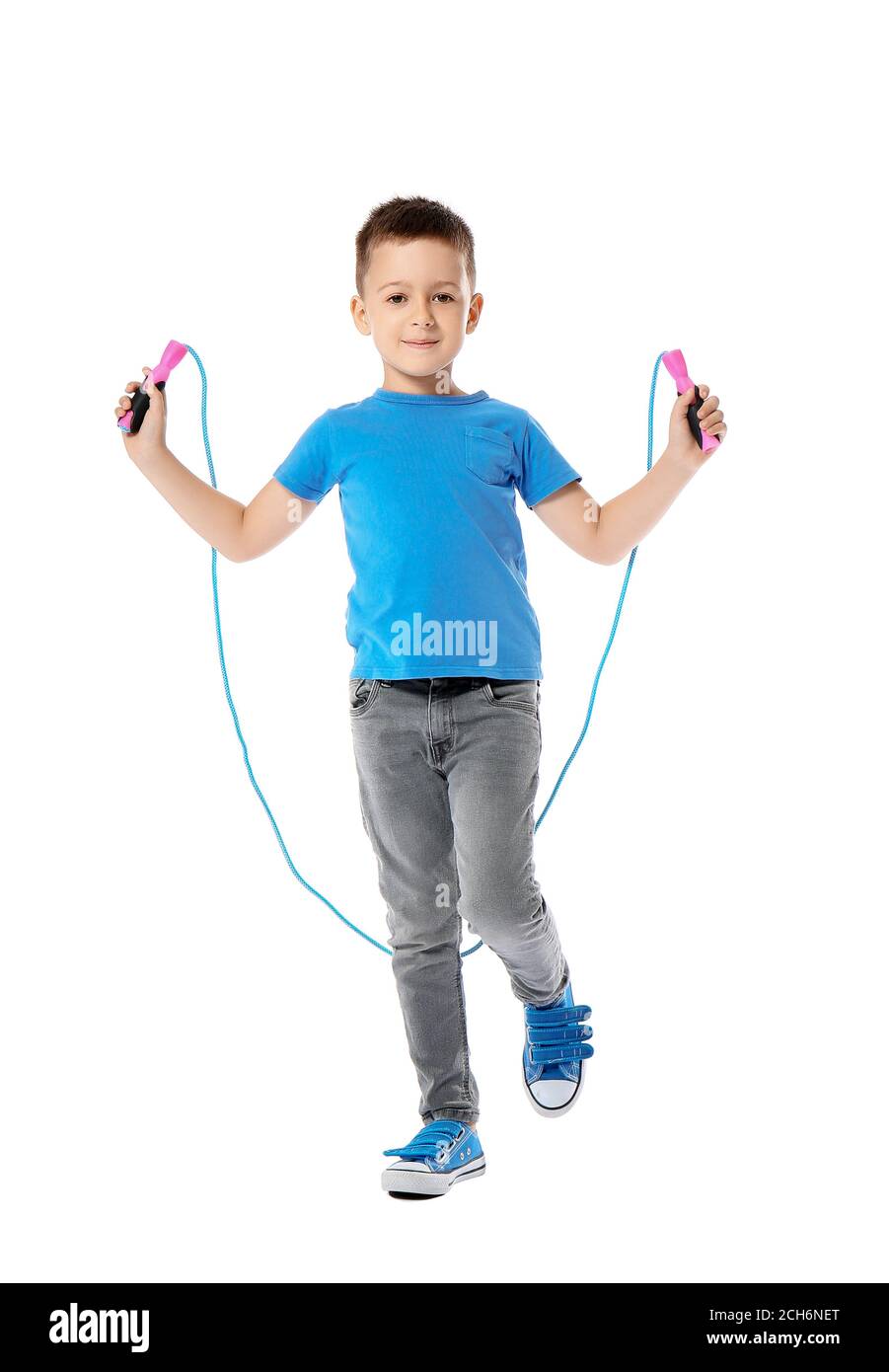 Cute little boy jumping rope against white background Stock Photo - Alamy
