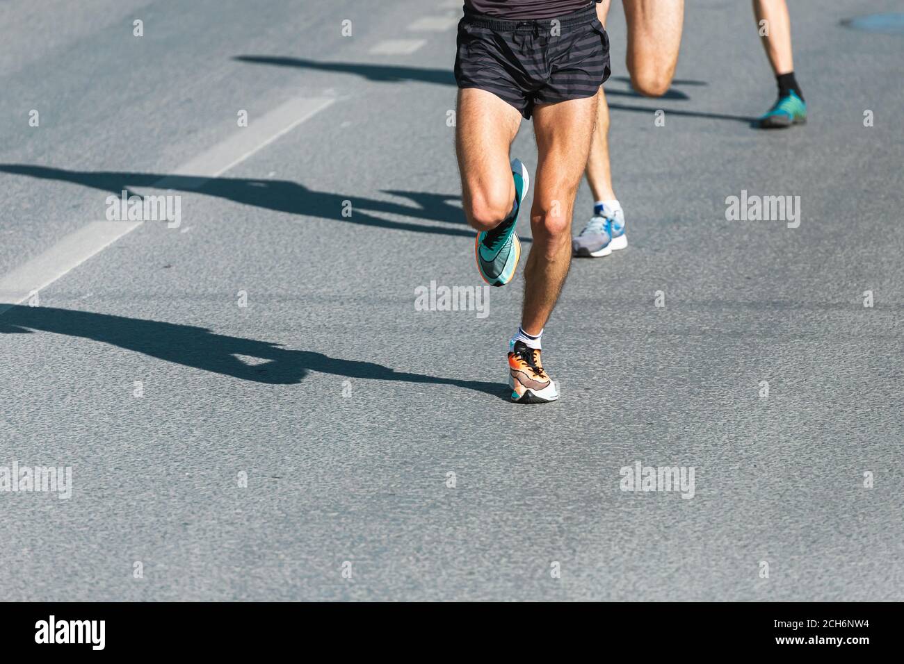 Marathon running race. Close up of the many runners feet on road racing ...