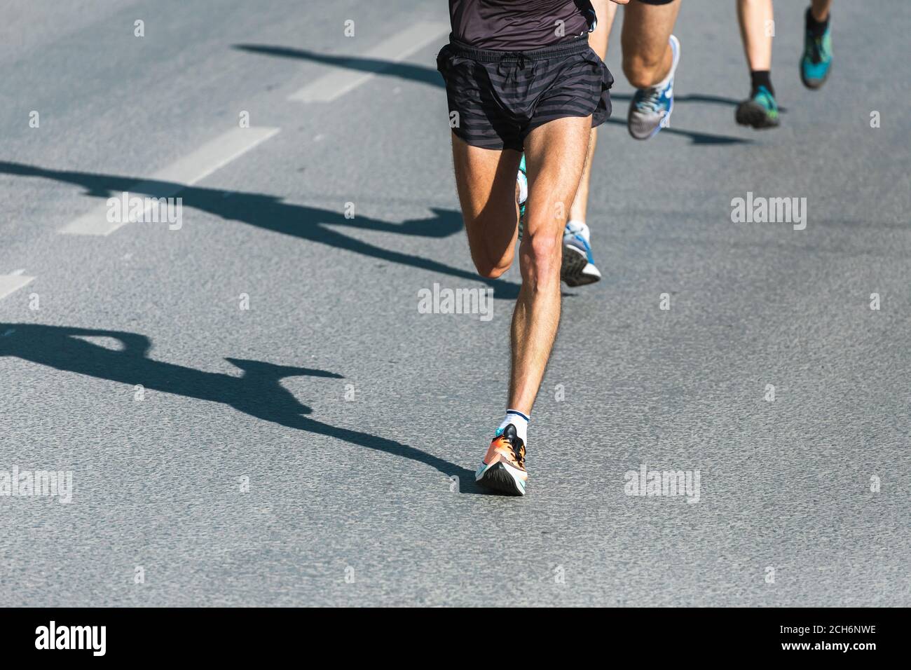 Marathon running race. Close up of the many runners feet on road racing ...