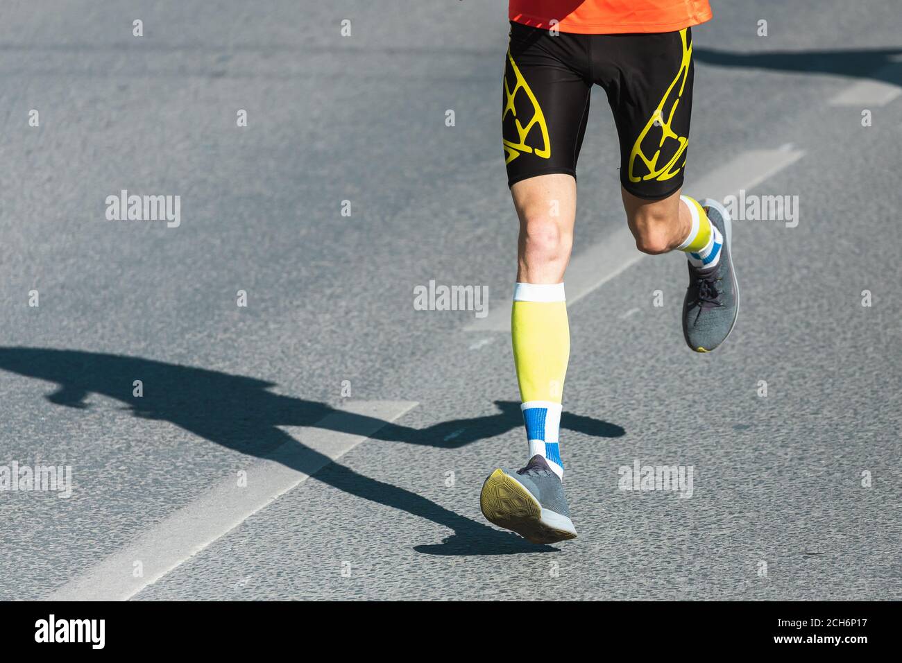 Running sports. Man runner legs and shoes in action on the road ...