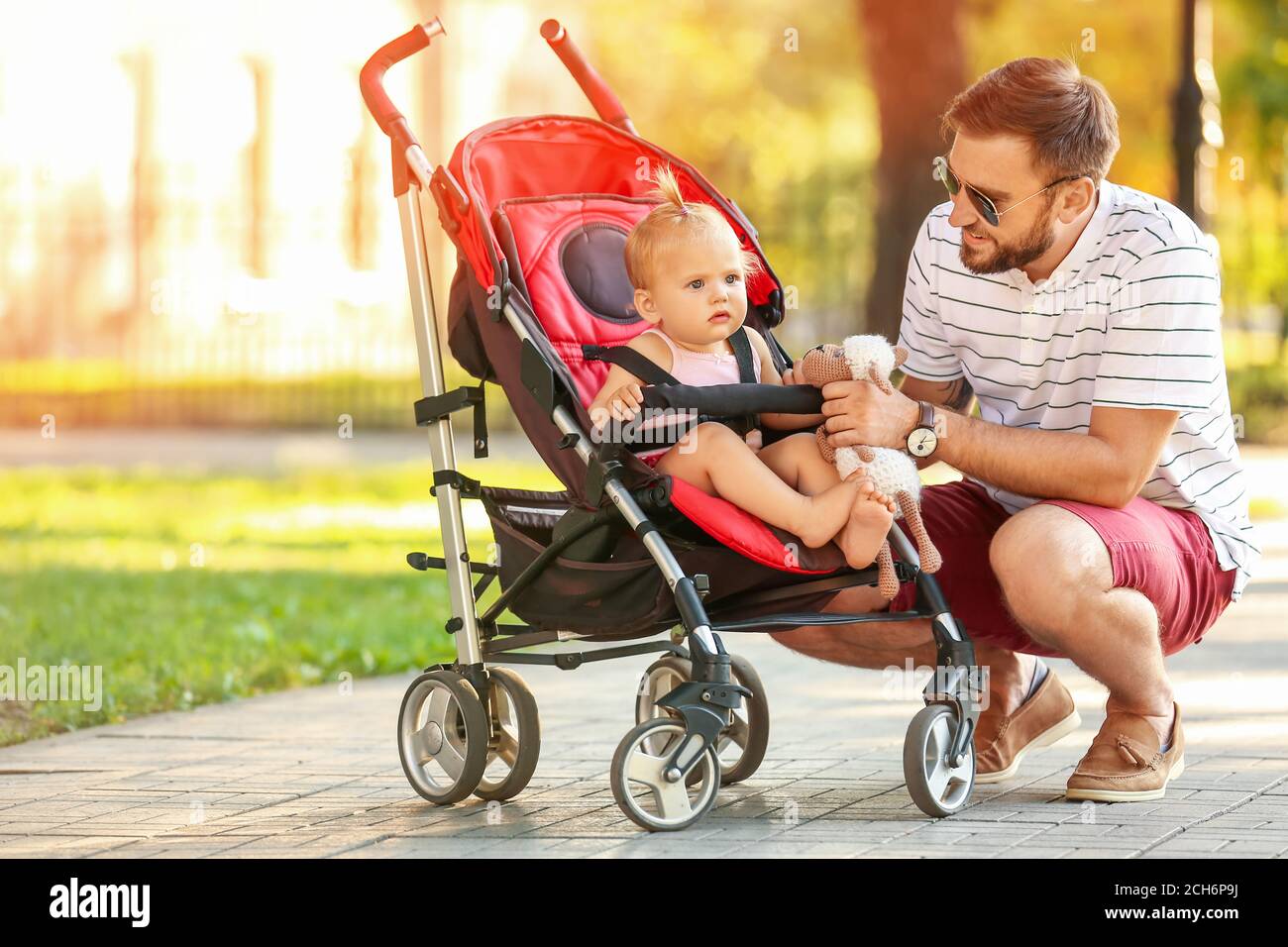 Man and his cute baby in stroller outdoors Stock Photo - Alamy