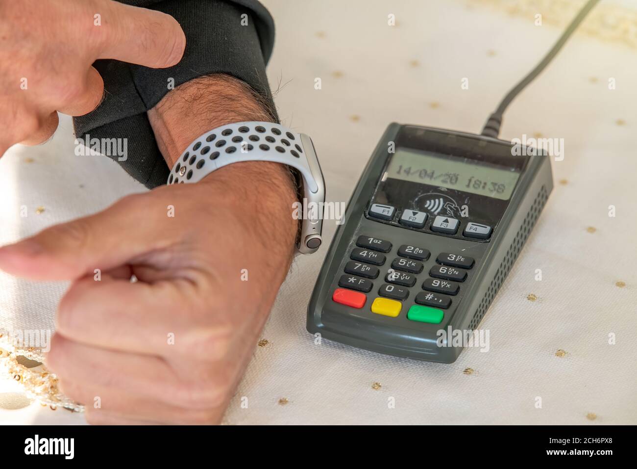 Man paying at the shop with his smart watch. Contactless payment ...