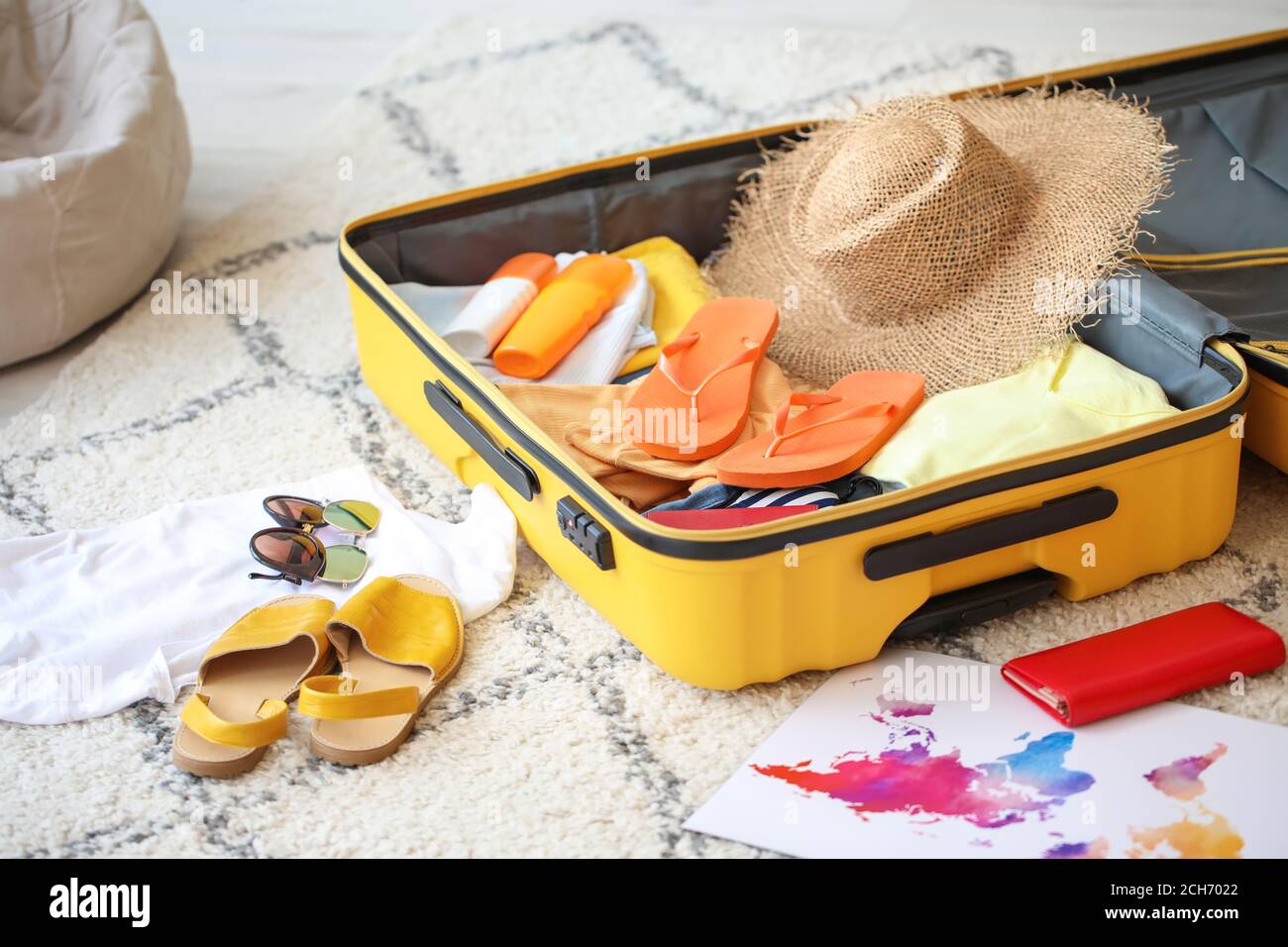 Open packed suitcase on floor in room. Travel concept Stock Photo - Alamy