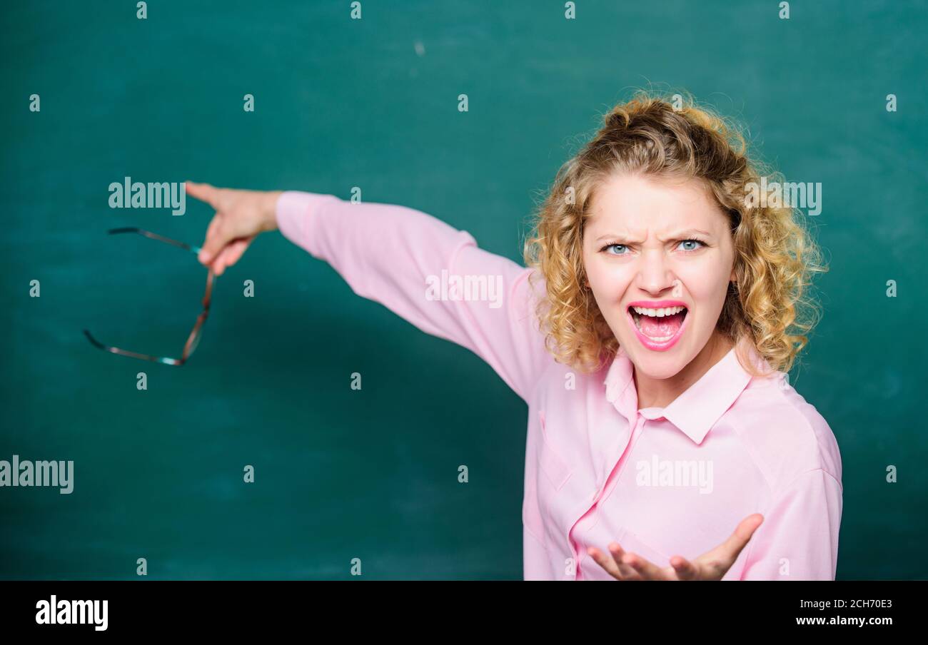 Remember this. Strict woman teacher pointing at chalkboard. Informing ...