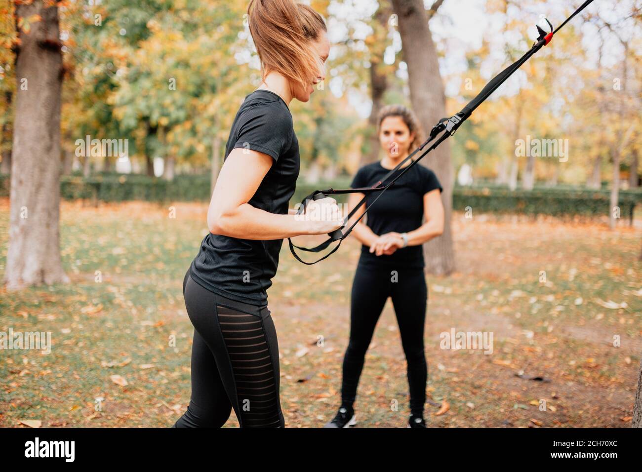 Woman training outside trx hi-res stock photography and images - Alamy