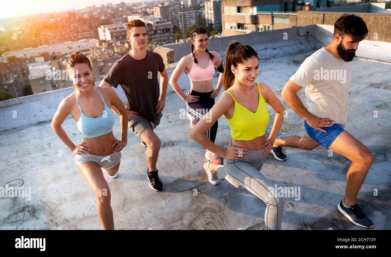 Portrait of smiling fit happy people doing power fitness exercise Stock ...