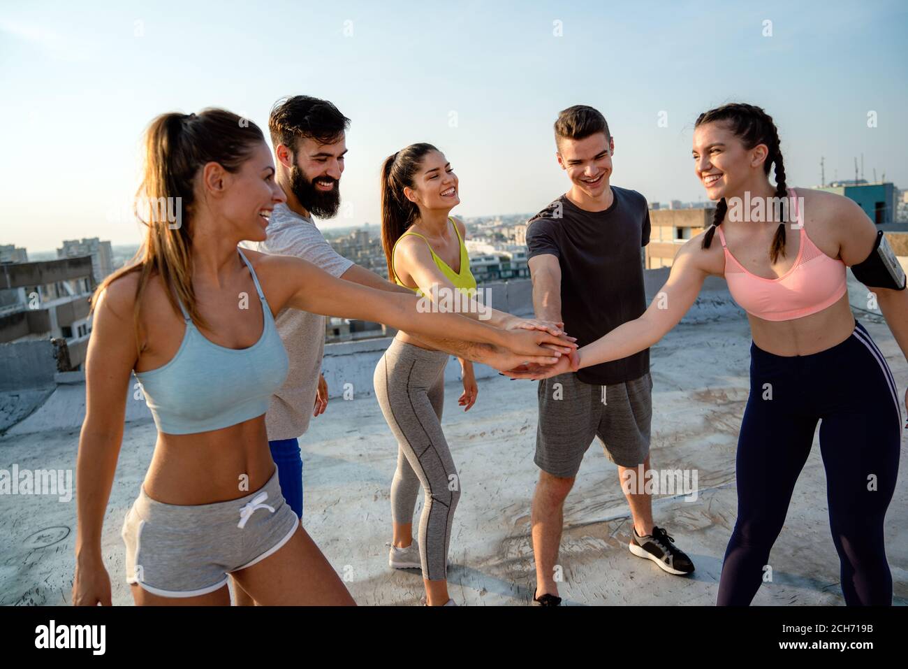 Portrait of smiling fit happy people doing power fitness exercise Stock ...