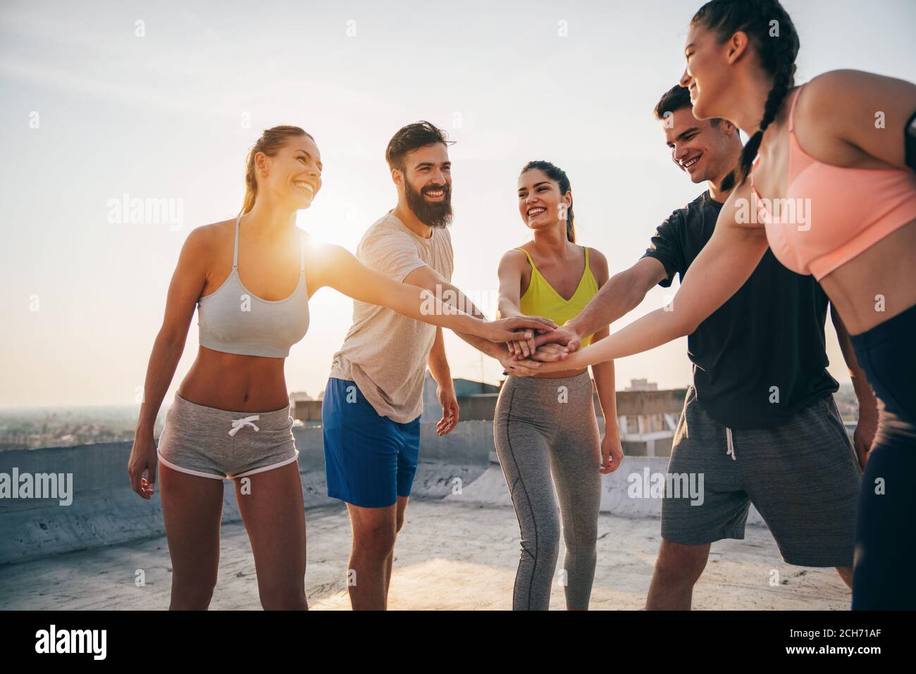 Group of fit healthy friends, people exercising together outdoor Stock ...