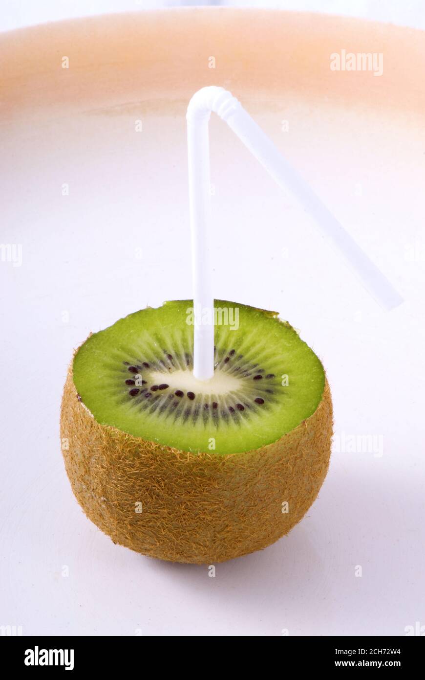 Kiwi with a straw. Kiwi juice. Creative Stock Photo - Alamy