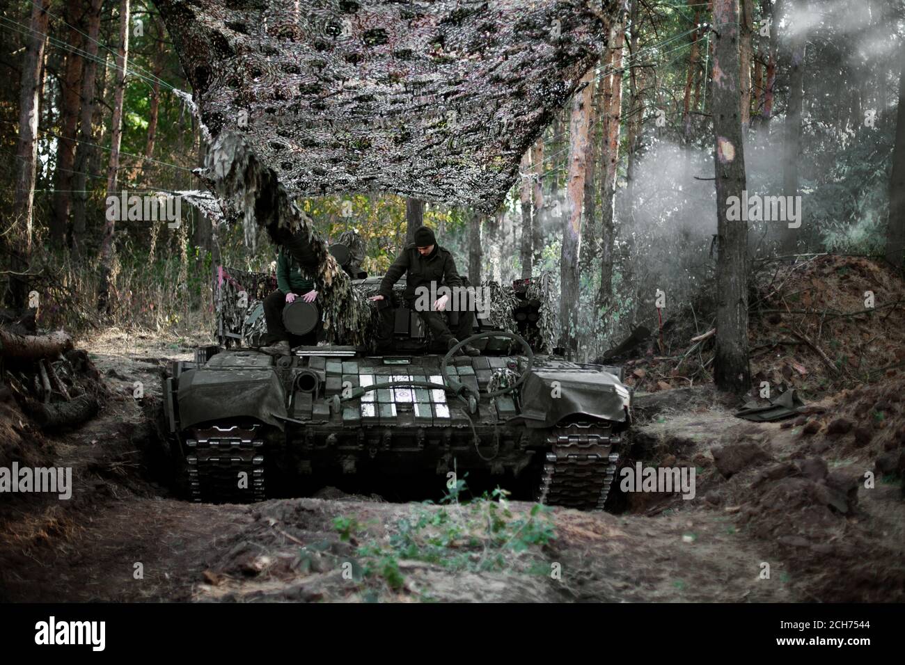 panzer T-64 is disguised and hidden in a caponniere in a coniferous ...