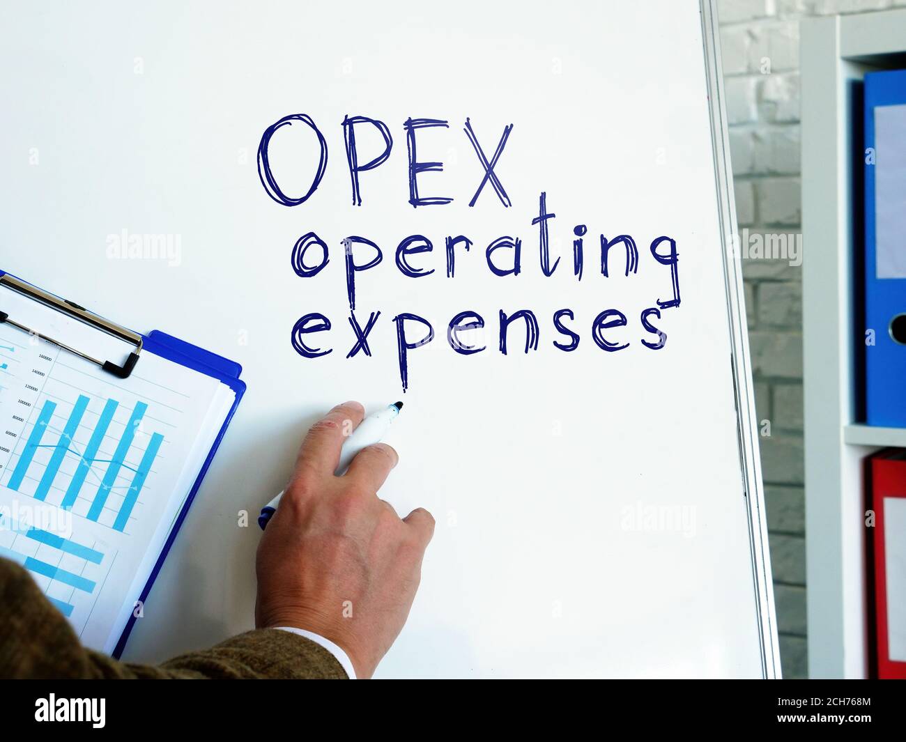 OPEX operating expense businessman wrote on the whiteboard Stock Photo ...