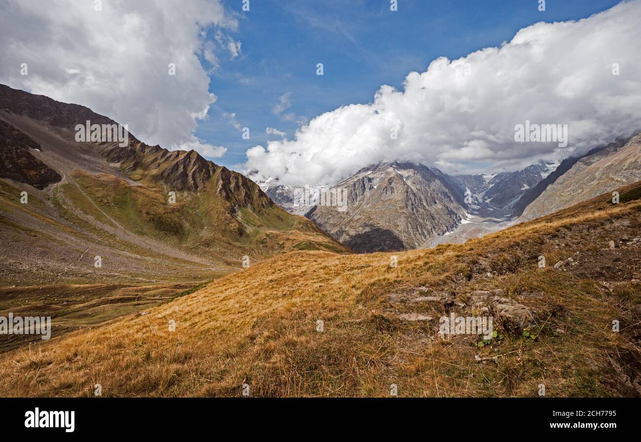 Panorama of a Alpine mountain valley and peaks. High mountain peaks and ...