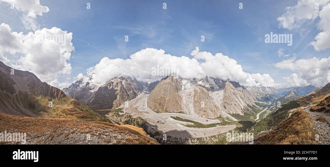 Panorama of a Alpine mountain valley and peaks. High mountain peaks and ...