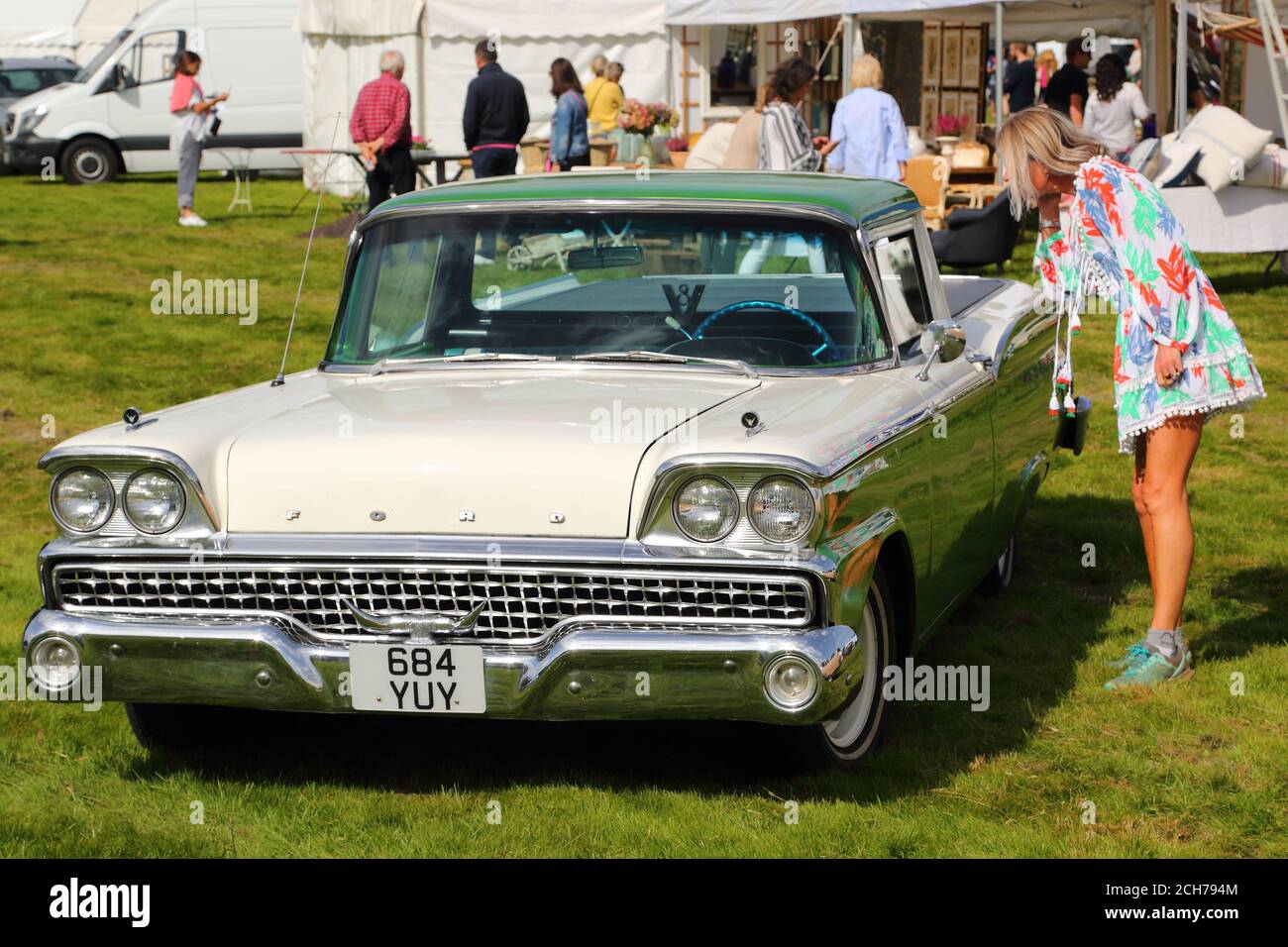 A young woman admires a 1950s Ford Fairlane at the Decor Fair in Henley ...