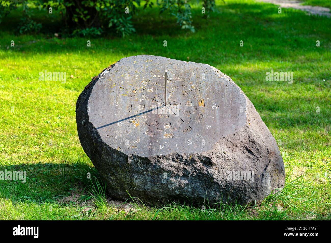 An old sundial made of a large stone with a metal rod, the clock will ...