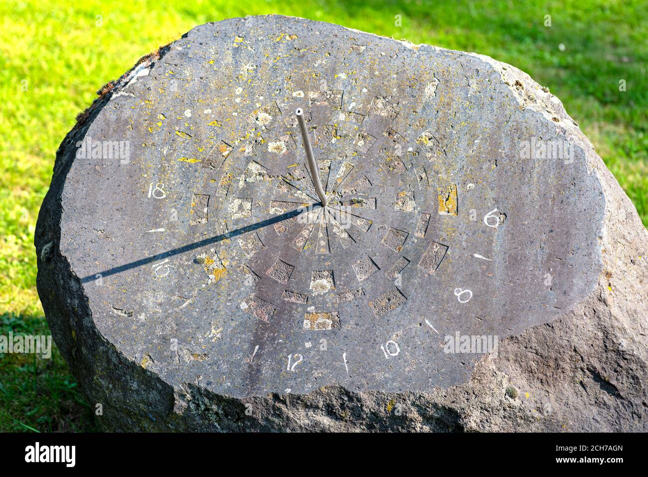 An old sundial made of a large stone with a metal rod, the clock will ...