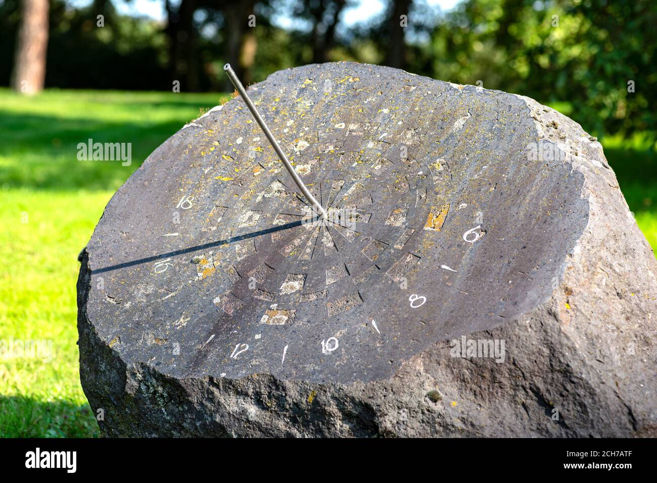 An old sundial made of a large stone with a metal rod, the clock will ...