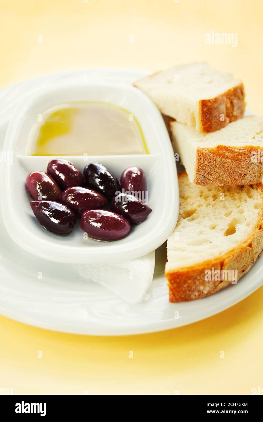 Traditional Greek starter - olives with olive oil and bread (selective ...