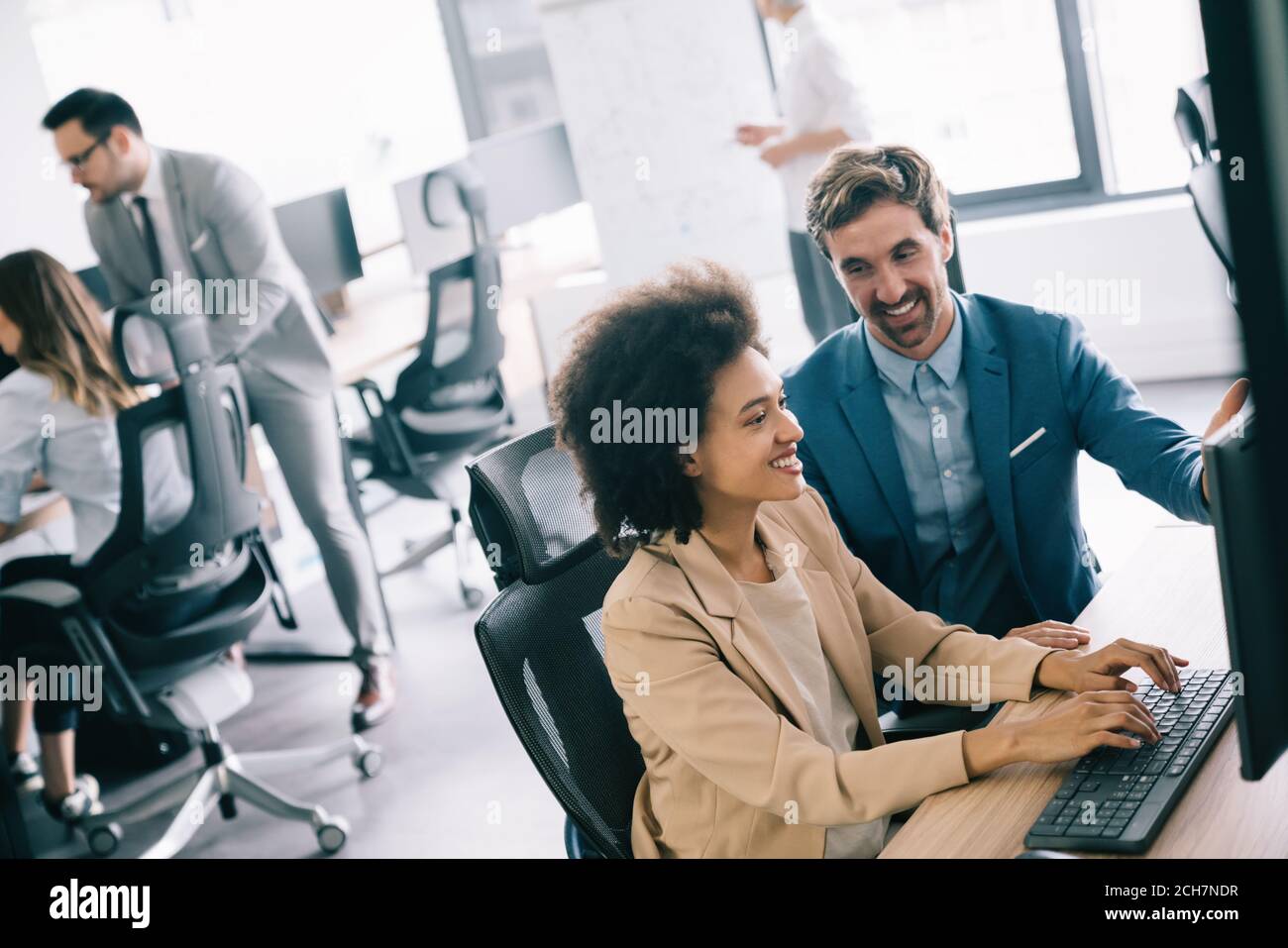 Creative people working in office on computer Stock Photo - Alamy